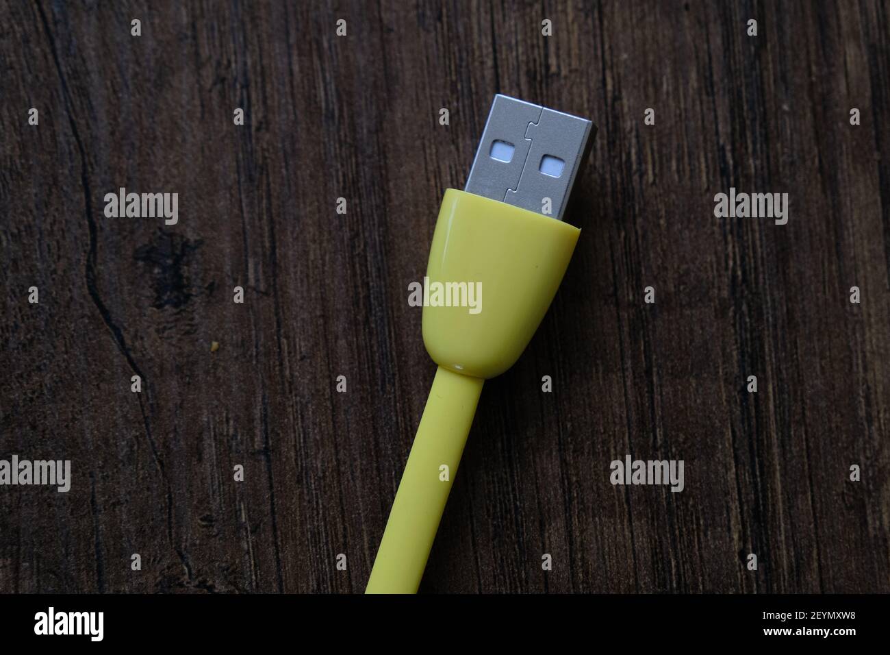 Yellow colored USB type cable staying on dark wooden table Stock Photo ...