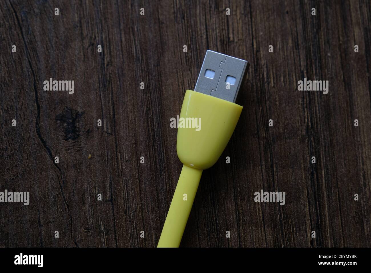 Yellow colored USB type cable staying on dark wooden table Stock Photo ...