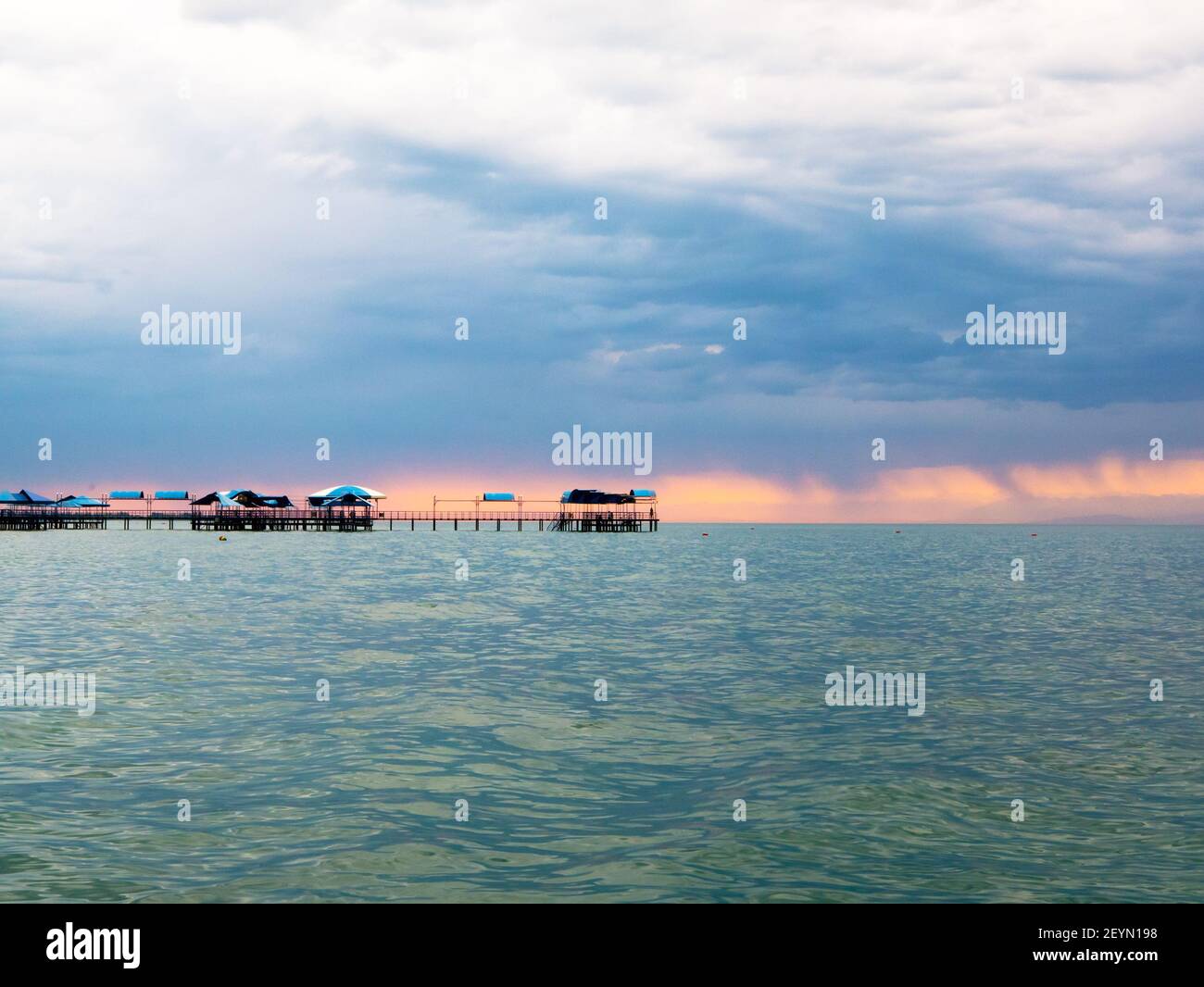 Bad weather on the beach. pier against the dawn. Spoiled vacation Stock ...