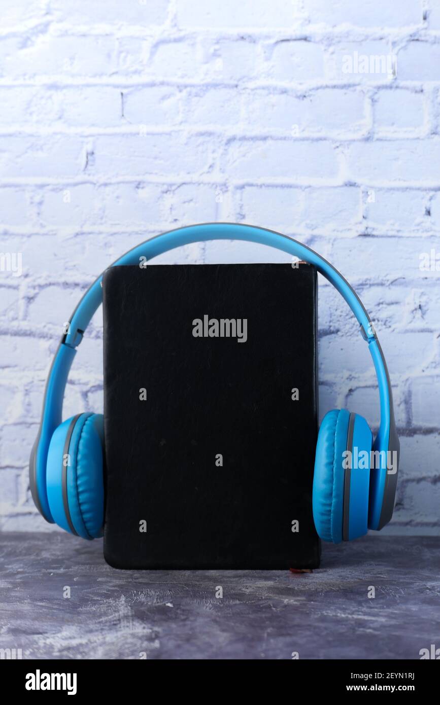 Audio book concept. Headphones and notepad on white background Stock ...