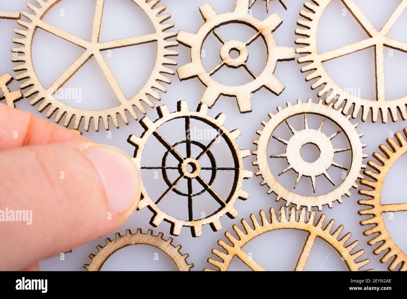 Hand holding gear wheels as the concept of mechanism Stock Photo - Alamy