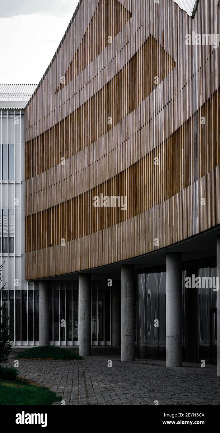 A vertical shot of a modern building exterior made of woods and ...