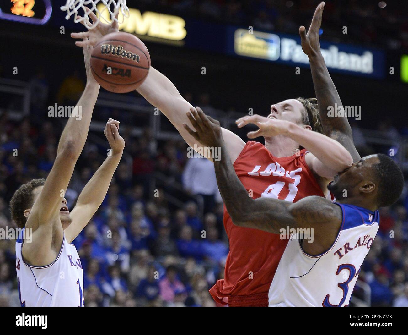 Kansas' Jamari Traylor, right, takes an elbow to the nose from New ...
