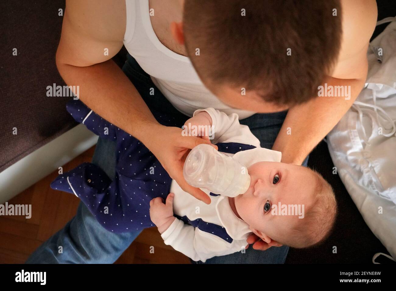 Young man feed newborn baby hi-res stock photography and images - Alamy
