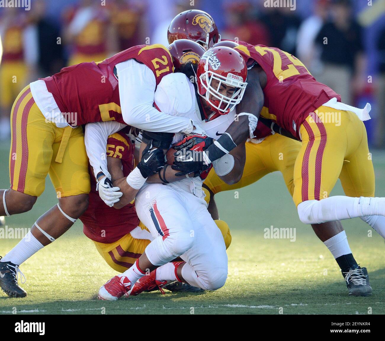 Fresno State's Josh Quezada, middle, is munched between USC tacklers in ...