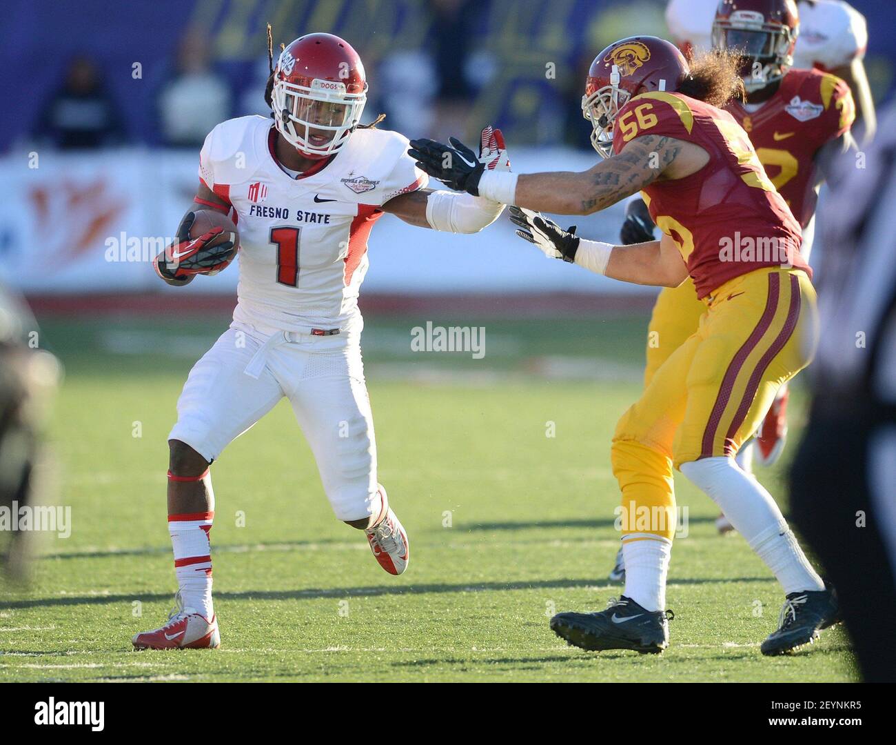 Fresno State's Isaiah Burse (1) tries to stiff-arm his way past USC's ...