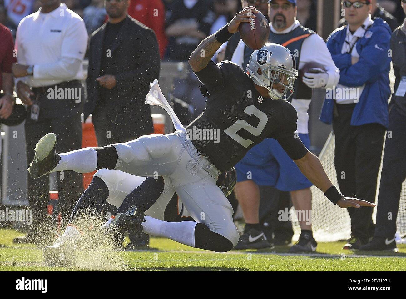 Oakland Raiders quarterback Terrelle Pryor (2) is tackled by Denver ...