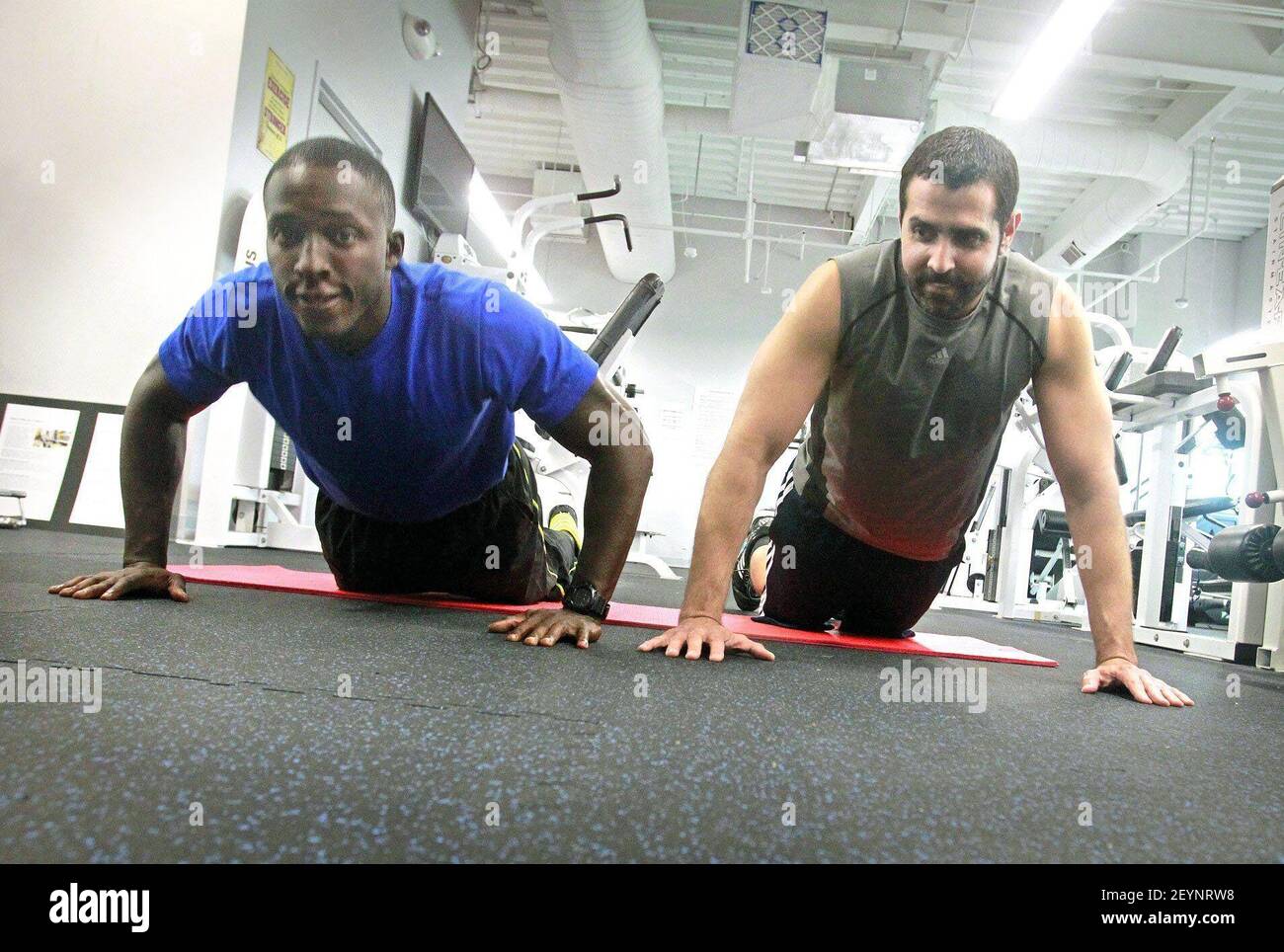 Fitness instructor Jeff Pierre, left, and editor Eddie Alvarez do ...