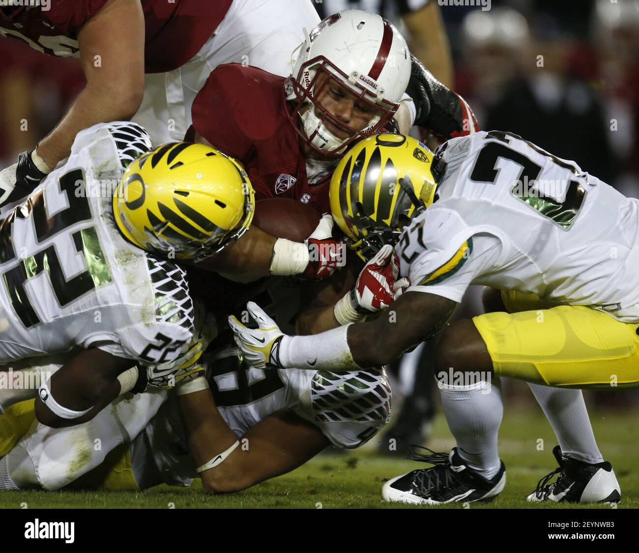 Tyler Gaffney, middle, of Stanford runs against the Oregon defense in ...