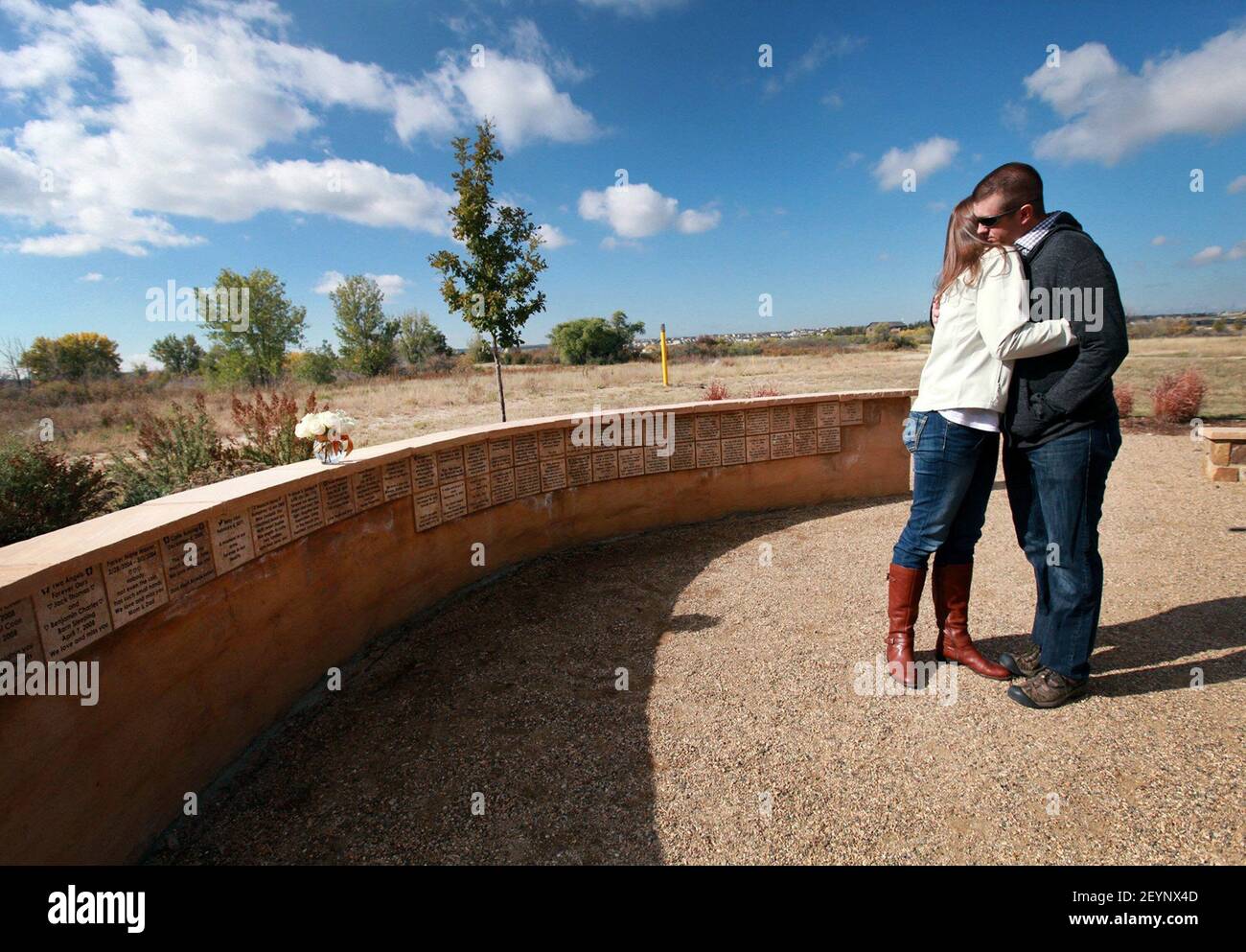 Sarah Wilkerson, left, and her husband Chris hug one another at the ...