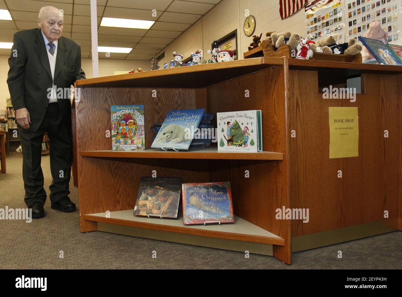 George Dunckel, 91, looks over the checkout counter in the library at ...