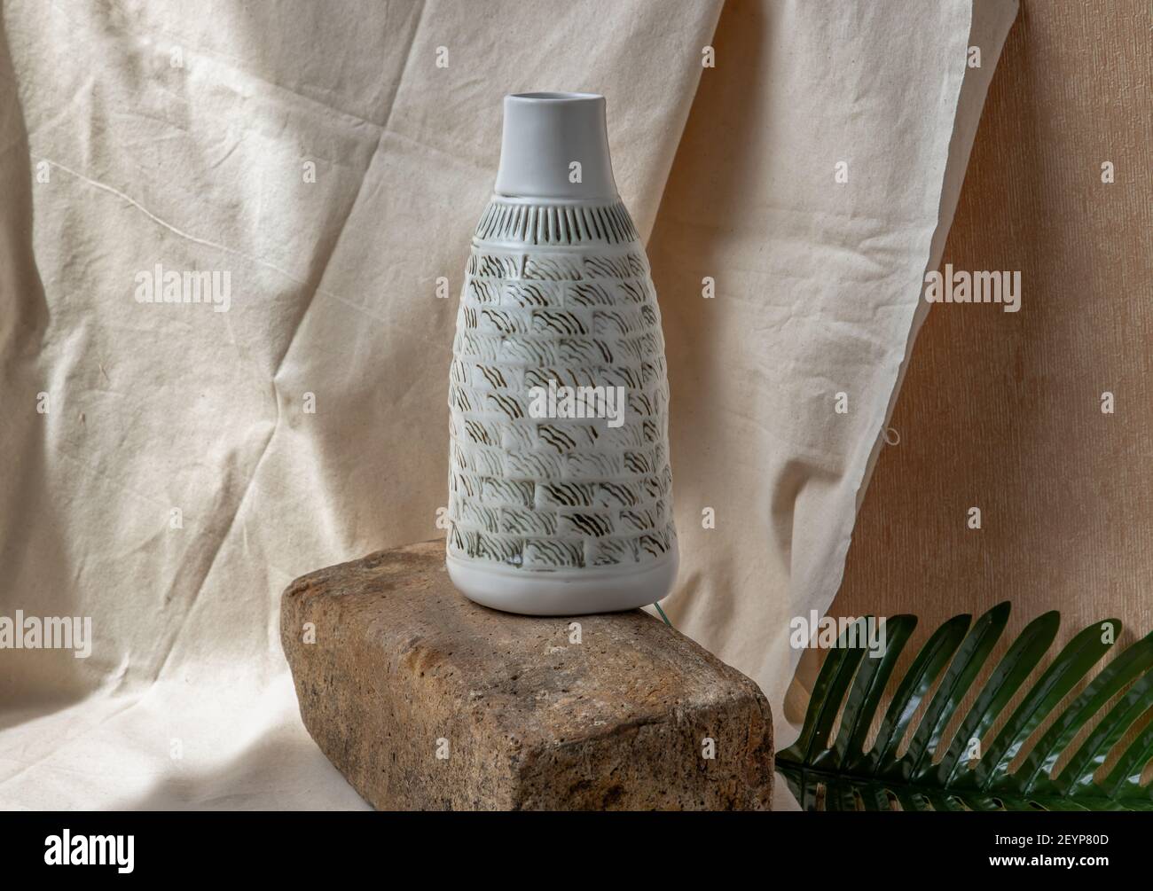 White and Black Handmade ceramic vase on white textured table cloth ...