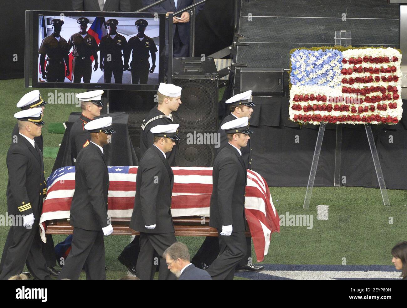 Members of the military carry the casket of Chris Kyle at Cowboys ...