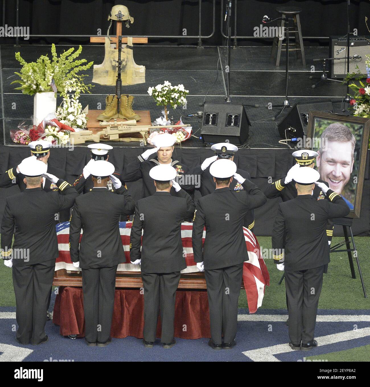 Members of the military salute the casket of Chris Kyle at Cowboys ...