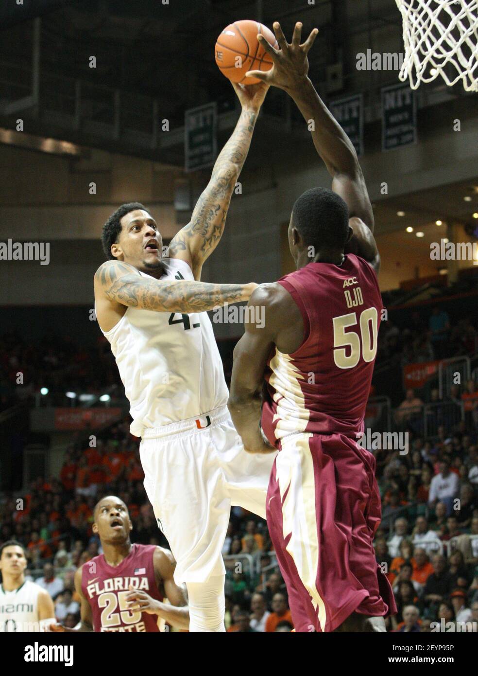 Miami's Julian Gamble puts up a shot over Florida State's Michael Ojo ...
