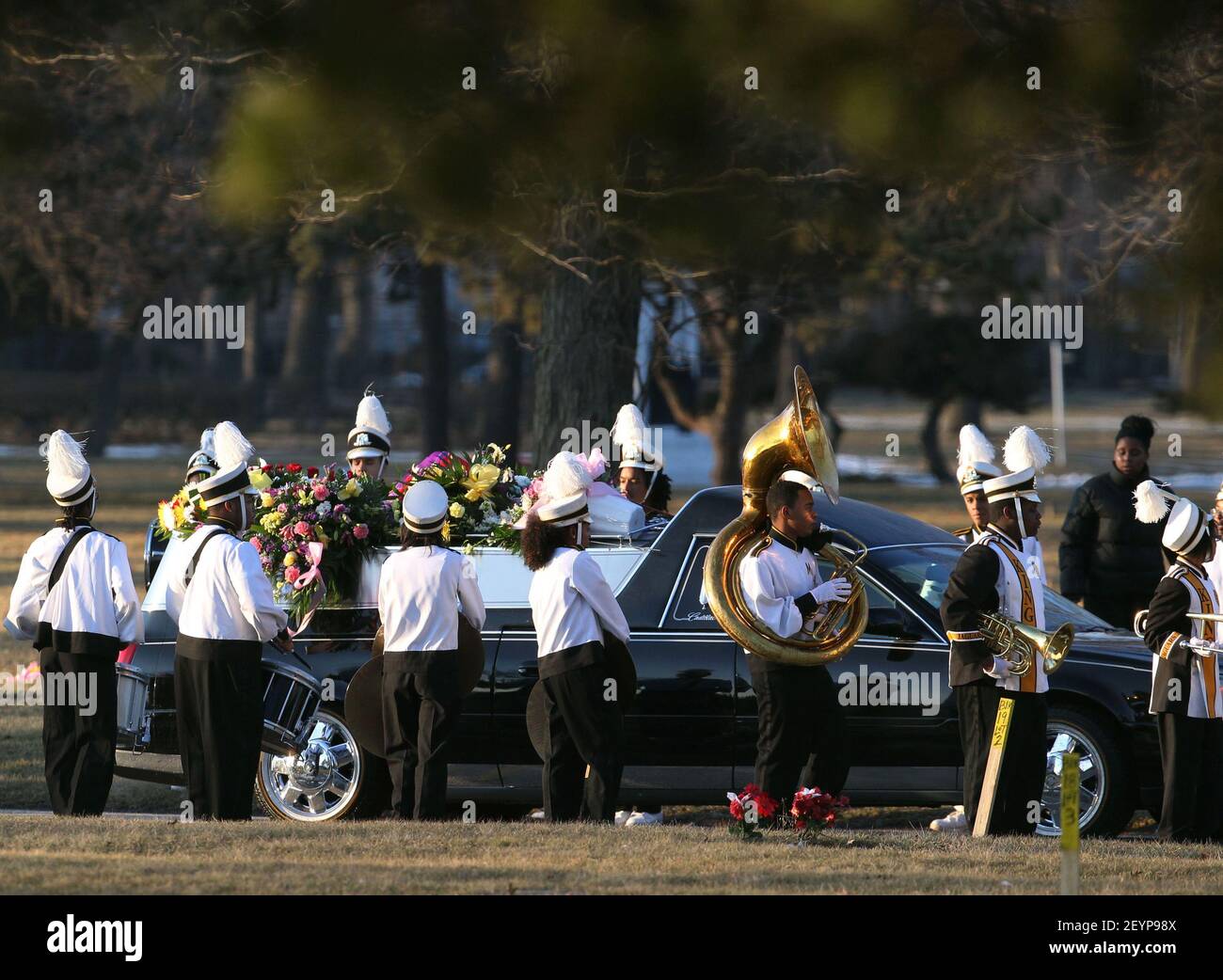 The King College Prep band plays as the hearse carrying the body of ...