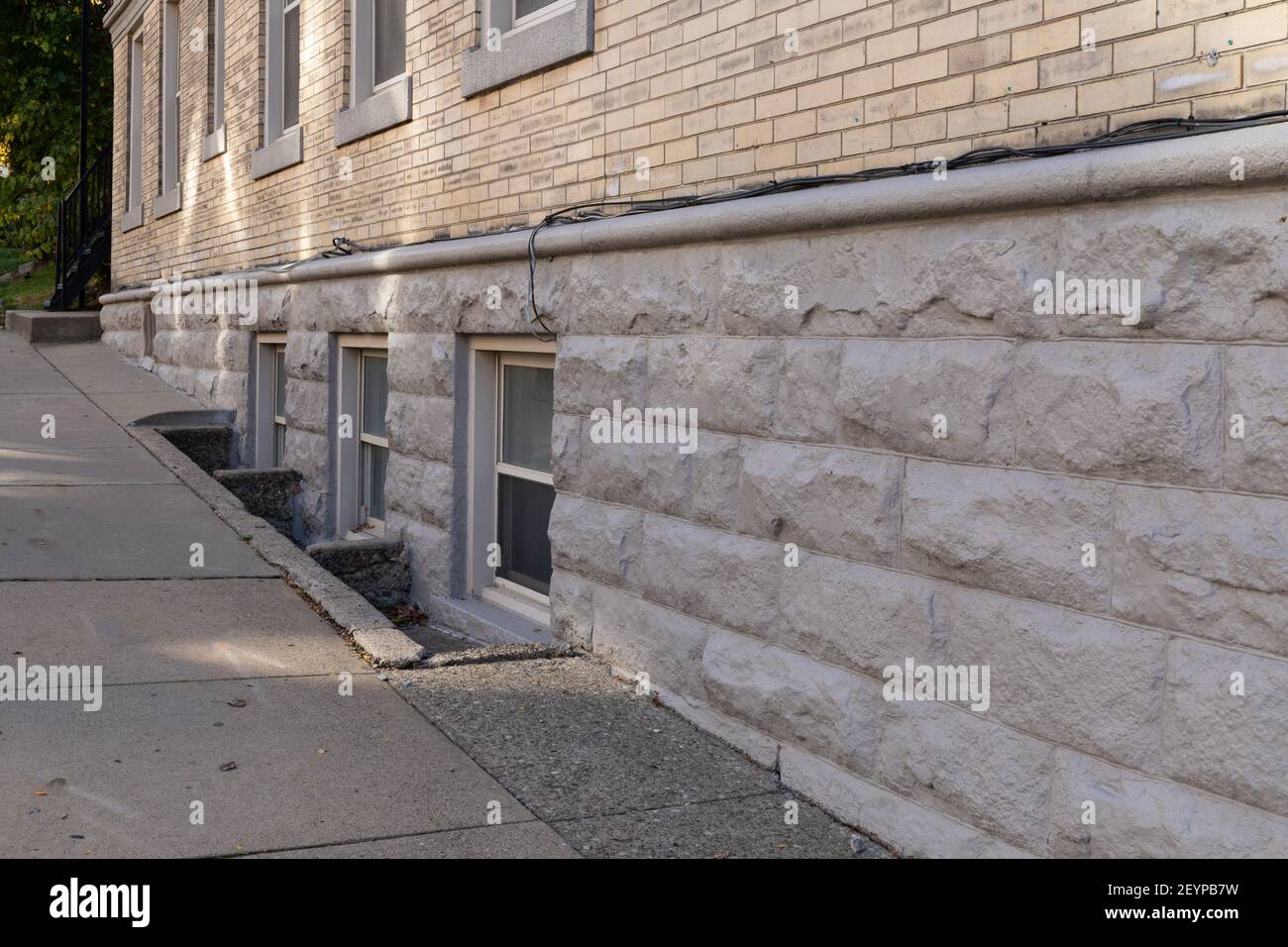 Basement window wells on a building made from rusticated stone and ...