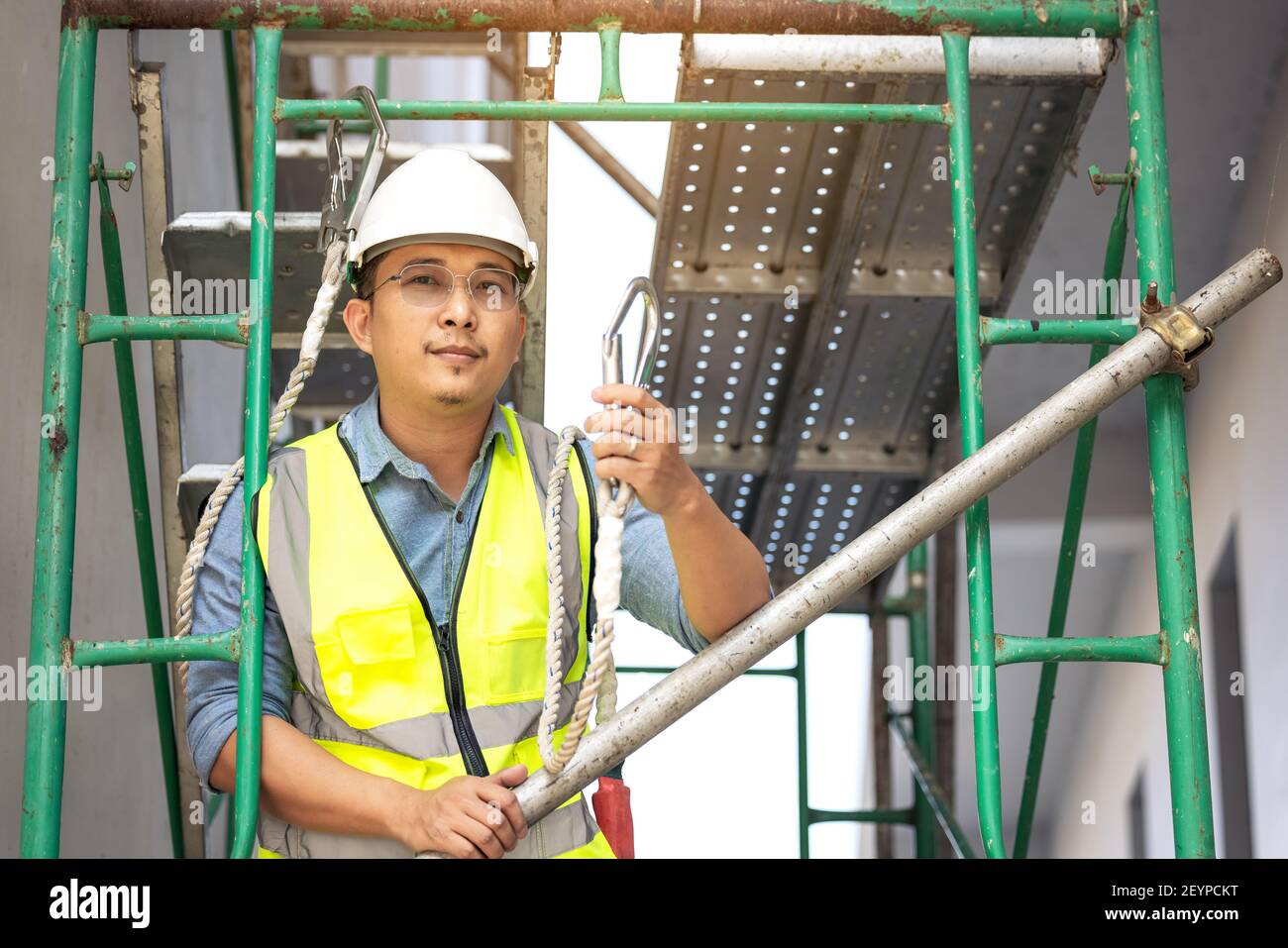 Young man worker or engineer climb ladder Stock Photo - Alamy