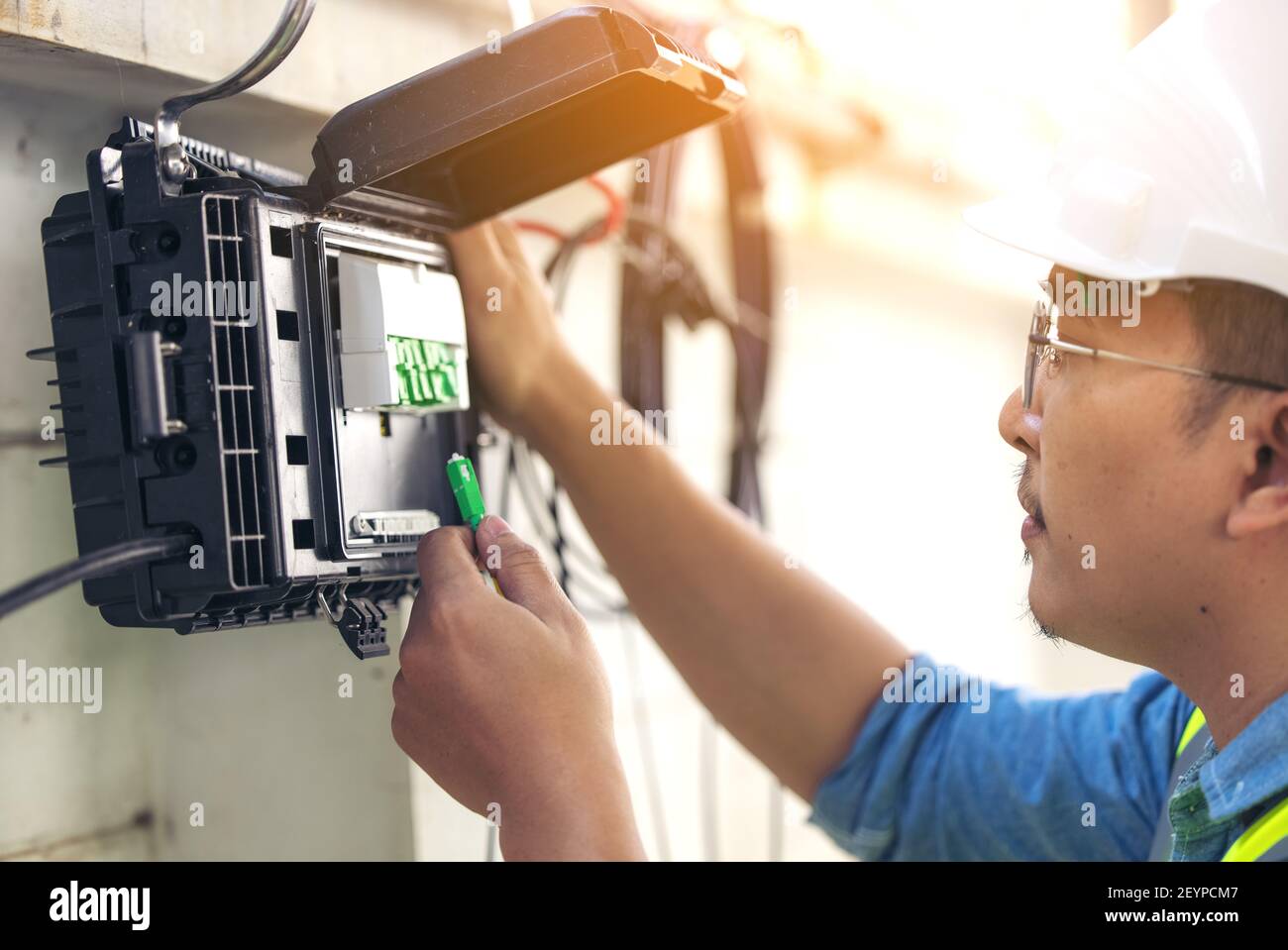 Engineer repair connector the fibers on splitter tray close-up outside ...
