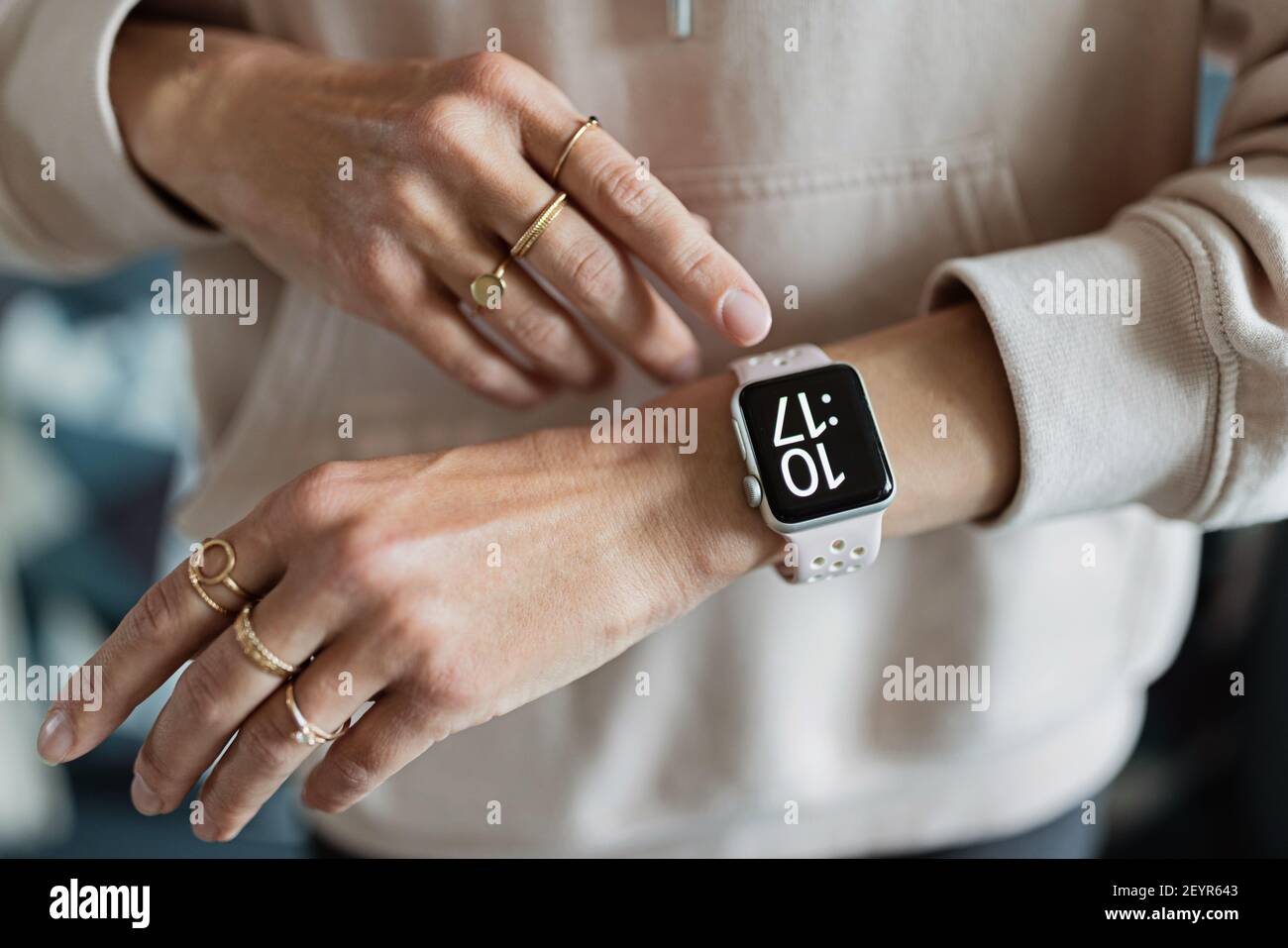 Closeup photo of female hand looking clock time on screen of smart ...