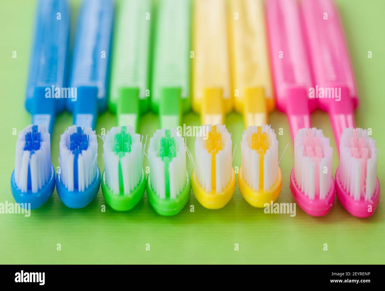 Colorful toothbrushes on green Stock Photo - Alamy