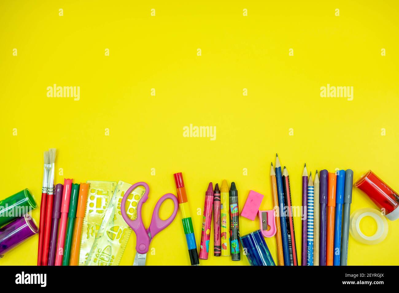 School supplies like pencil scissor eraser ruler watercolor on yellow ...