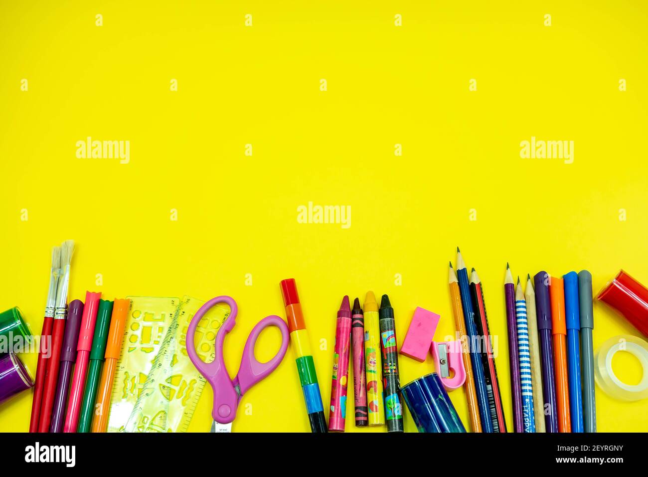 School supplies like pencil scissor eraser ruler watercolor on yellow ...