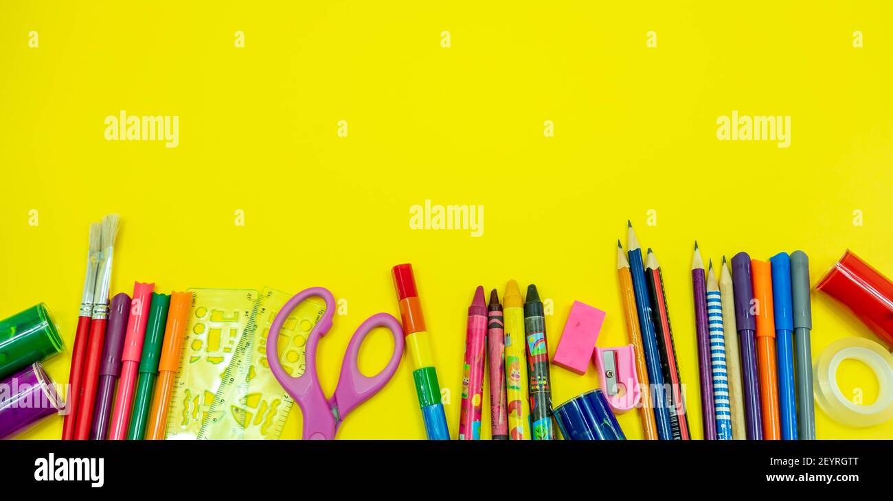 School supplies like pencil scissor eraser ruler watercolor on yellow ...