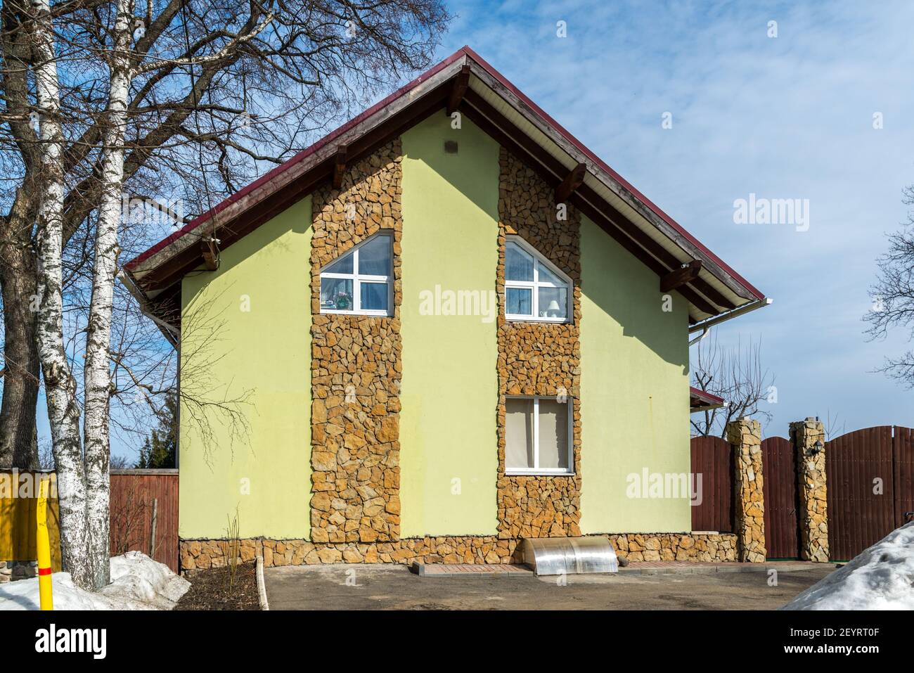 Standard two-storey cottage Finished decorative stone Stock Photo - Alamy