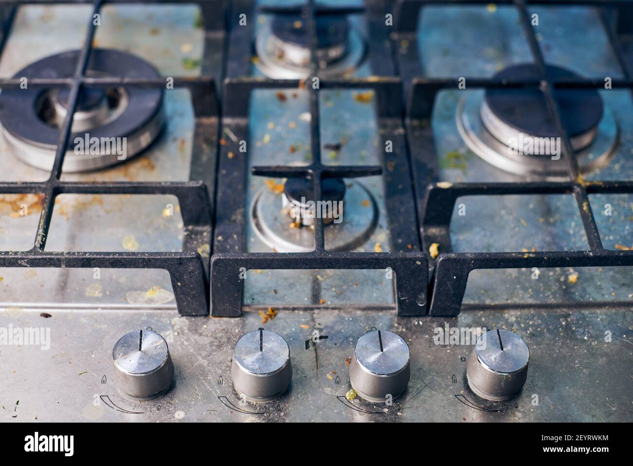 Dirty gas stove top with food leftovers. Unclean steel kitchen cooktop ...