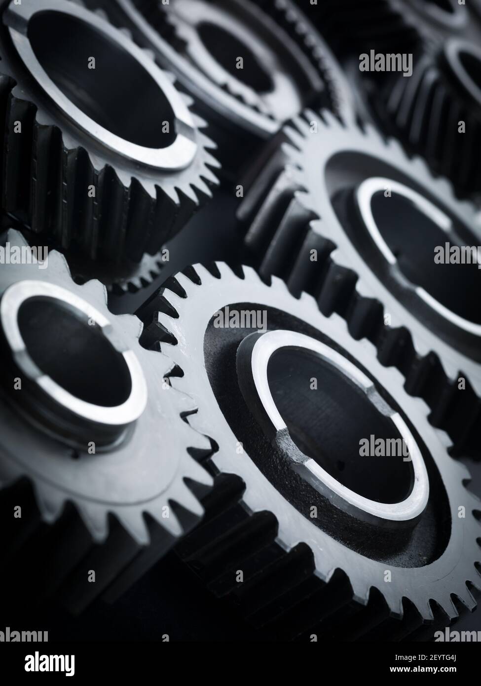 Black industrial gears and cogs on black background Stock Photo - Alamy