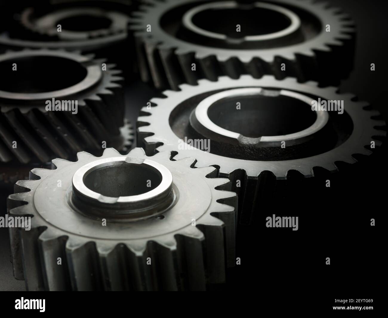 Industrial gears and cogs on black background Stock Photo - Alamy