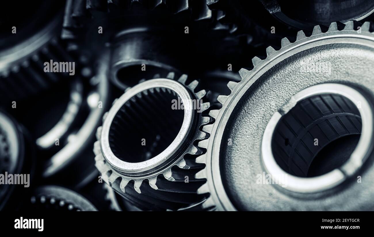 Blue tint black industrial gears and cogs on black background, banner ...