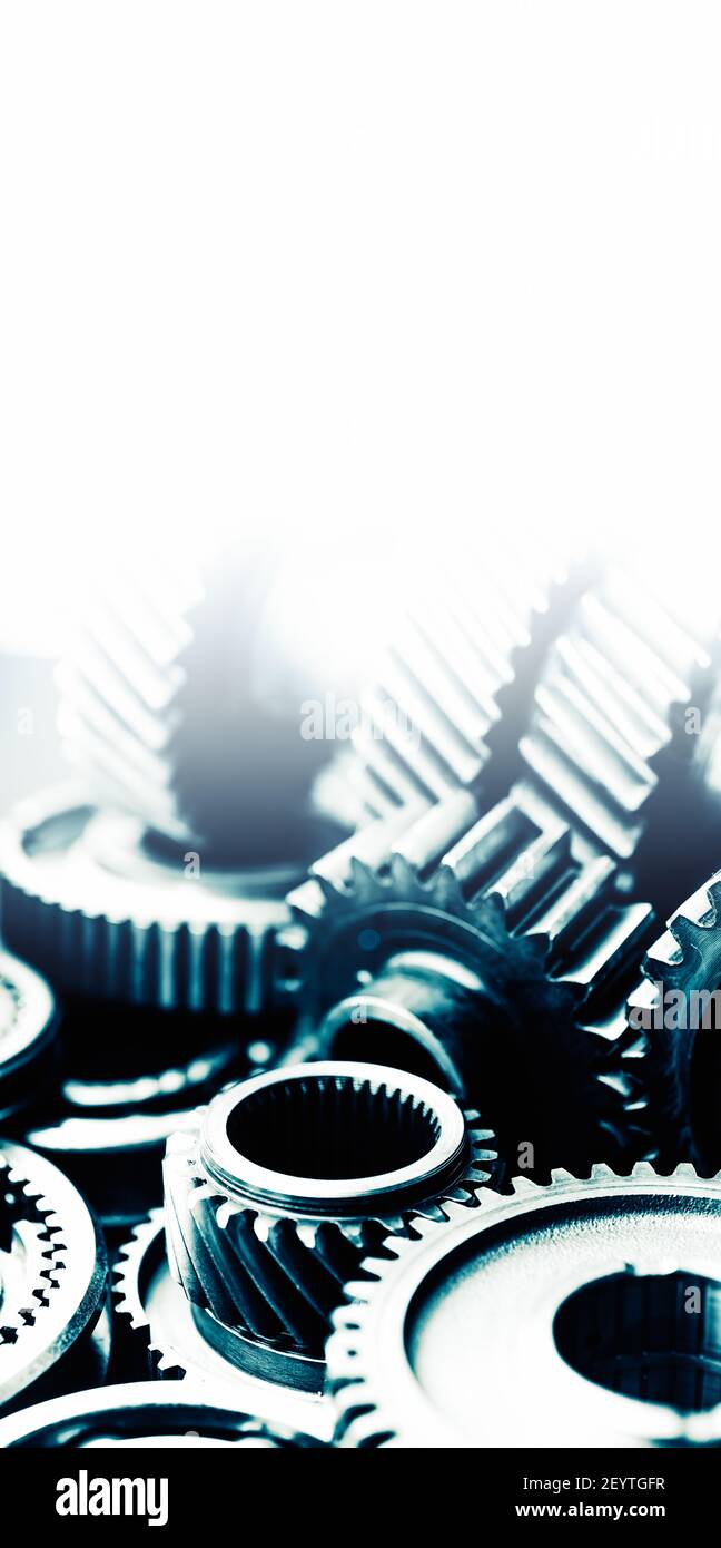 Industrial blue tint gears and cogs on white vertical background . Copy ...