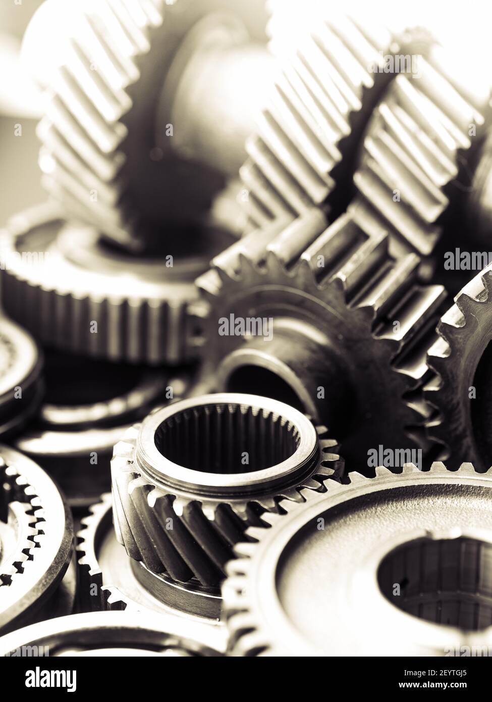 Black industrial gears and cogs on black background Stock Photo - Alamy