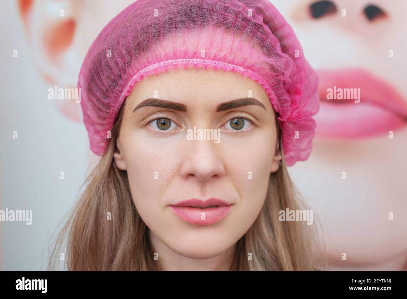 Young woman immediately after permanent eyebrow make-up procedure ...