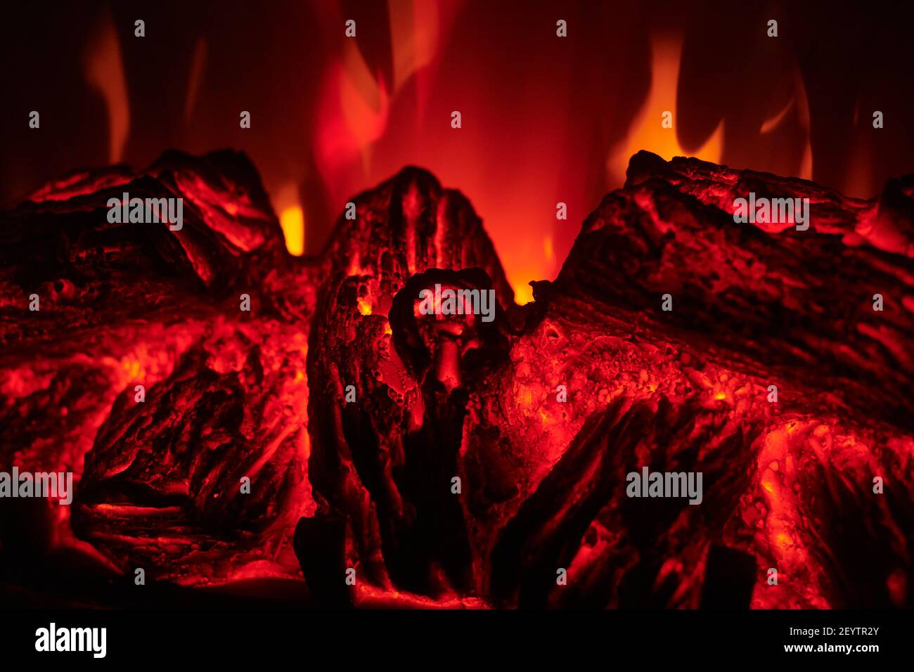 Artificial electric fireplace with orange, red and yellow flame. Fire ...