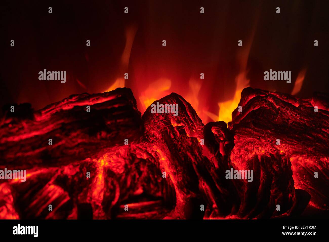 Artificial electric fireplace with orange, red and yellow flame. Fire ...