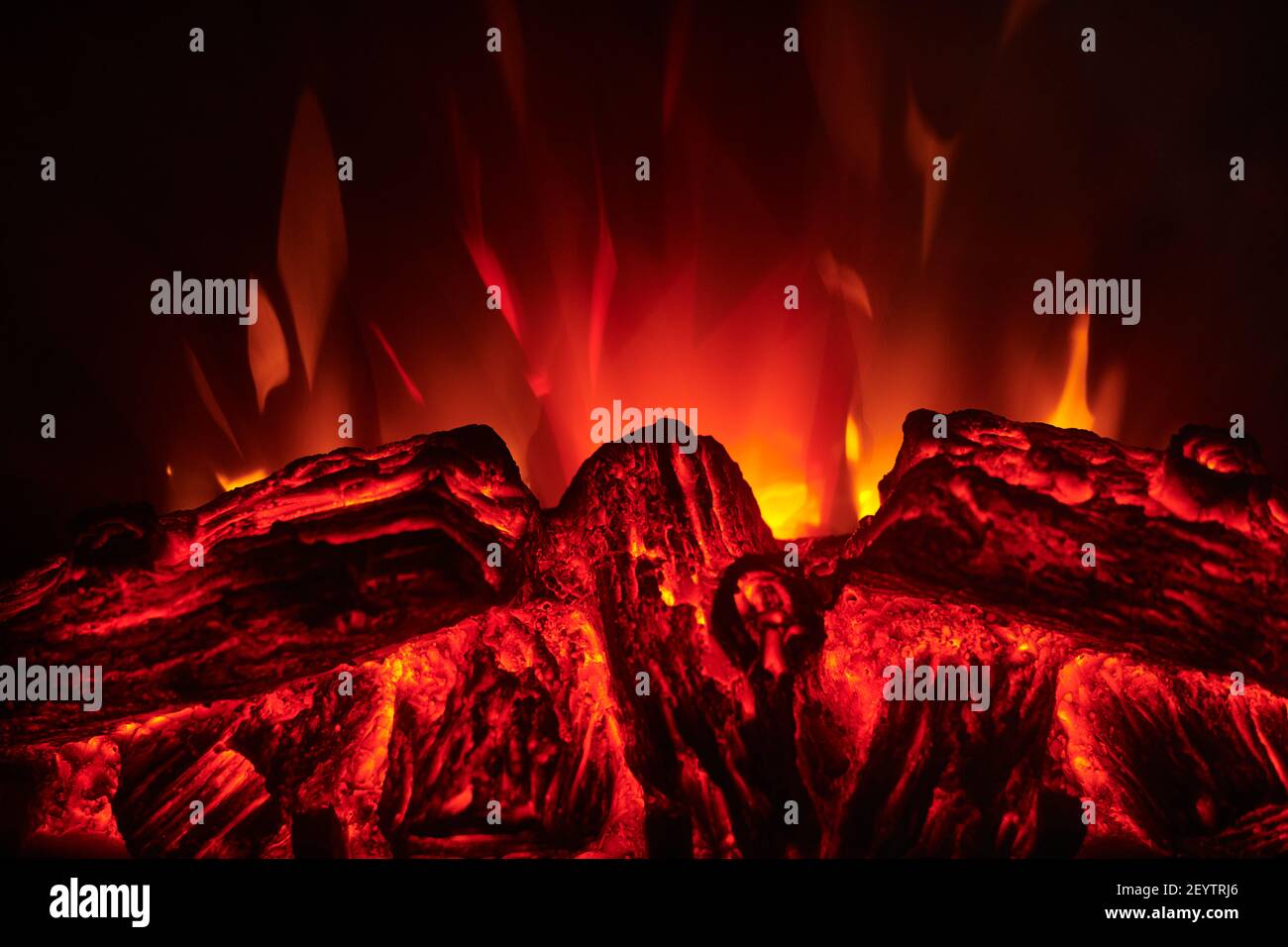 Artificial electric fireplace with red, orange and yellow flame ...