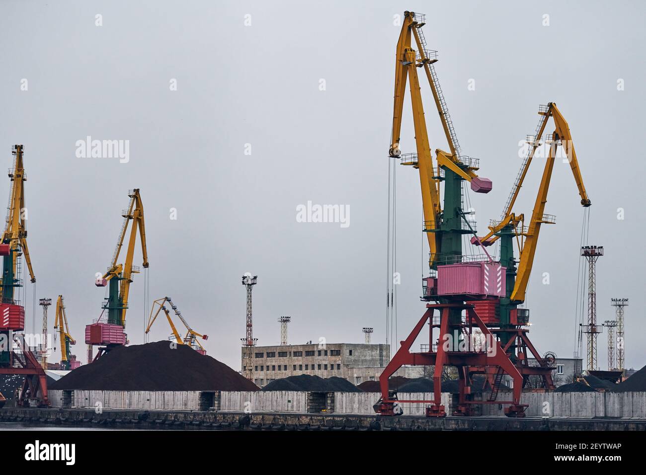 Massive harbor cranes in seaport. Heavy load dockside cranes in port ...
