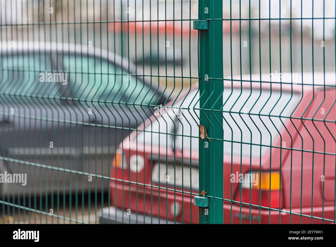 Fenced car parking lot with security. Guarded territory of paid hourly ...