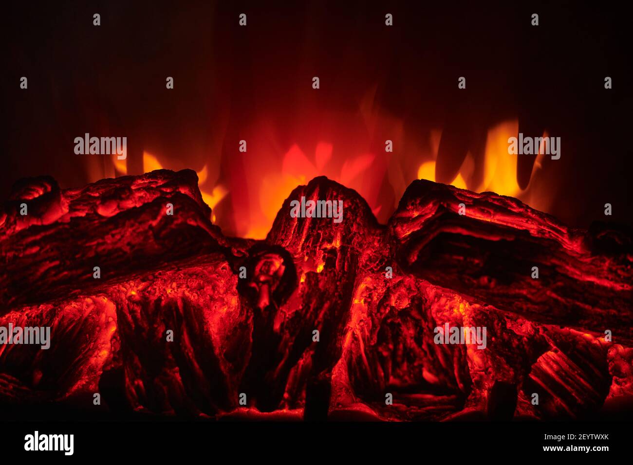 Artificial electric fireplace with red, orange and yellow flame ...