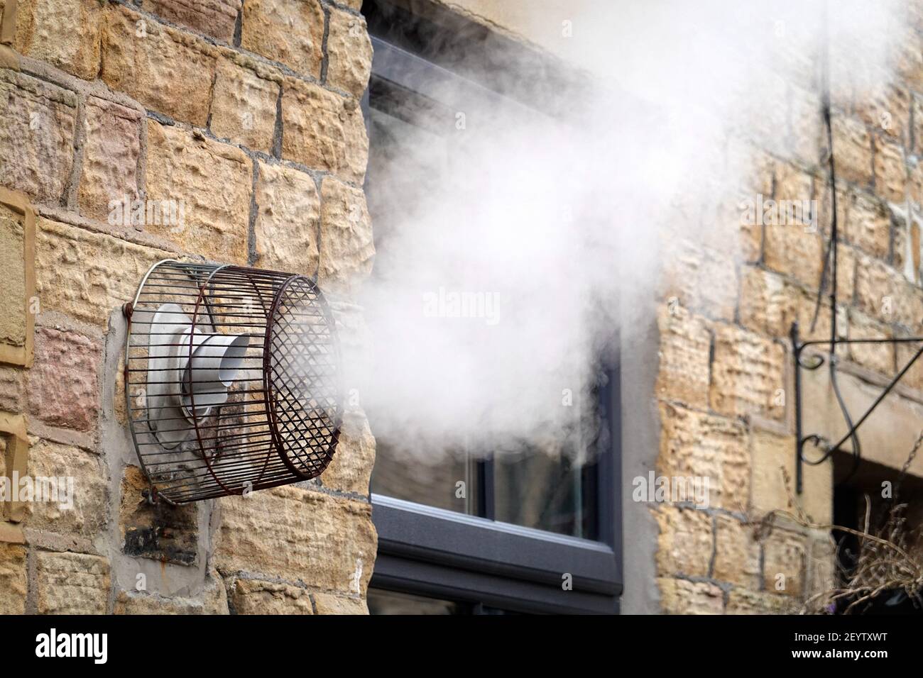 Steam pours from a flue on the outside of a house Stock Photo - Alamy