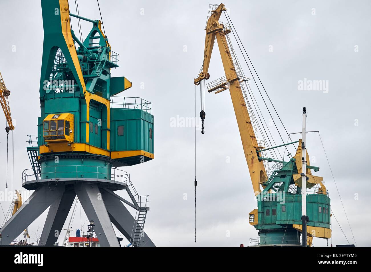 Massive harbor cranes in seaport. Heavy load dockside cranes in port ...