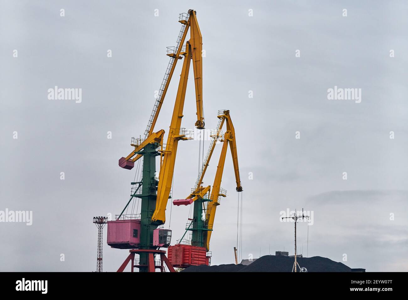 Massive harbor cranes in seaport. Heavy load dockside cranes in port ...