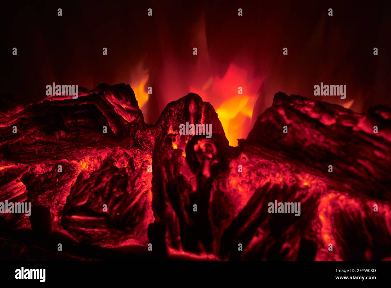 Artificial electric fireplace with orange, red and yellow flame. Fire ...