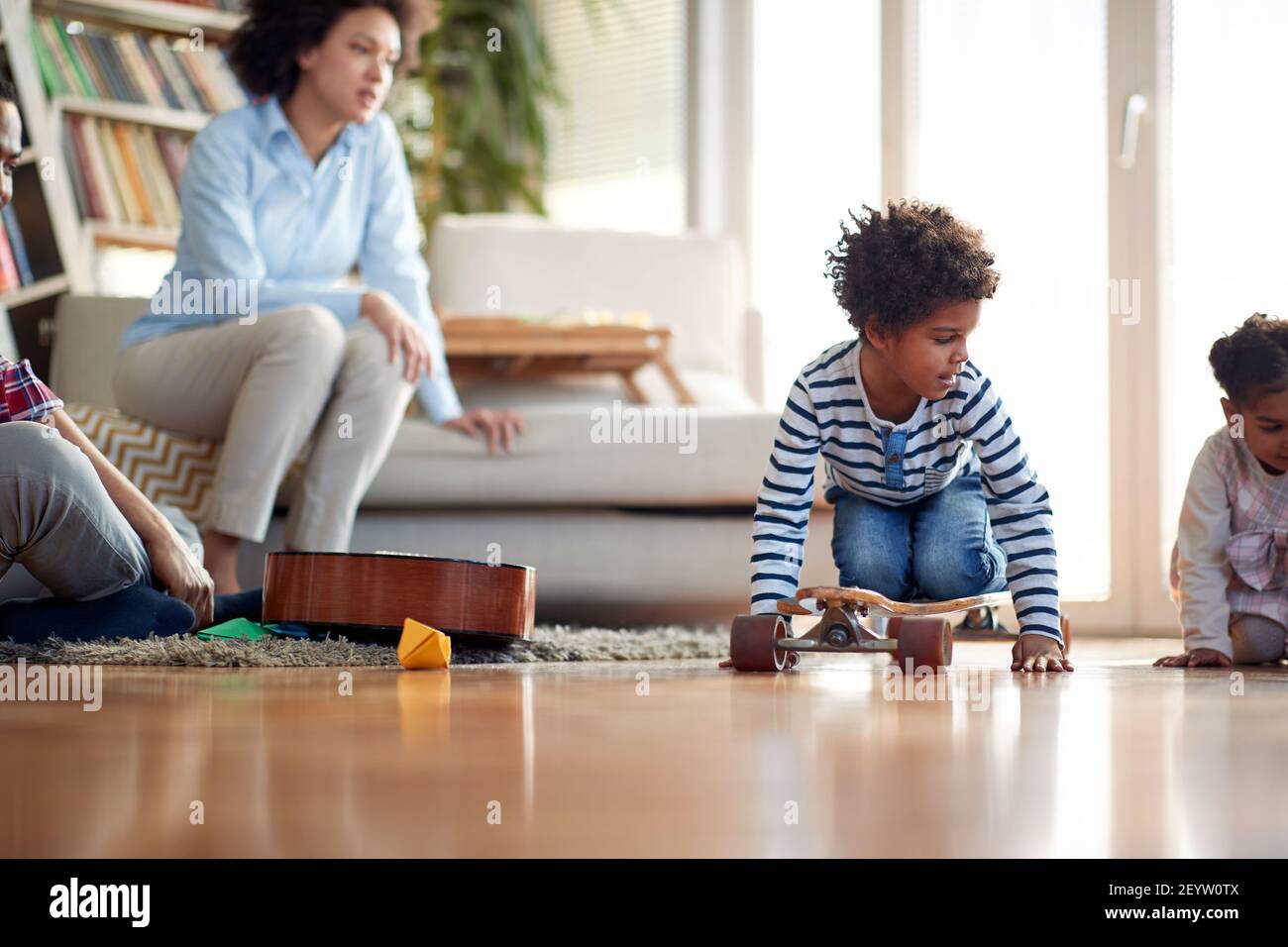 A young family spending quality time in a relaxed atmosphere at home ...