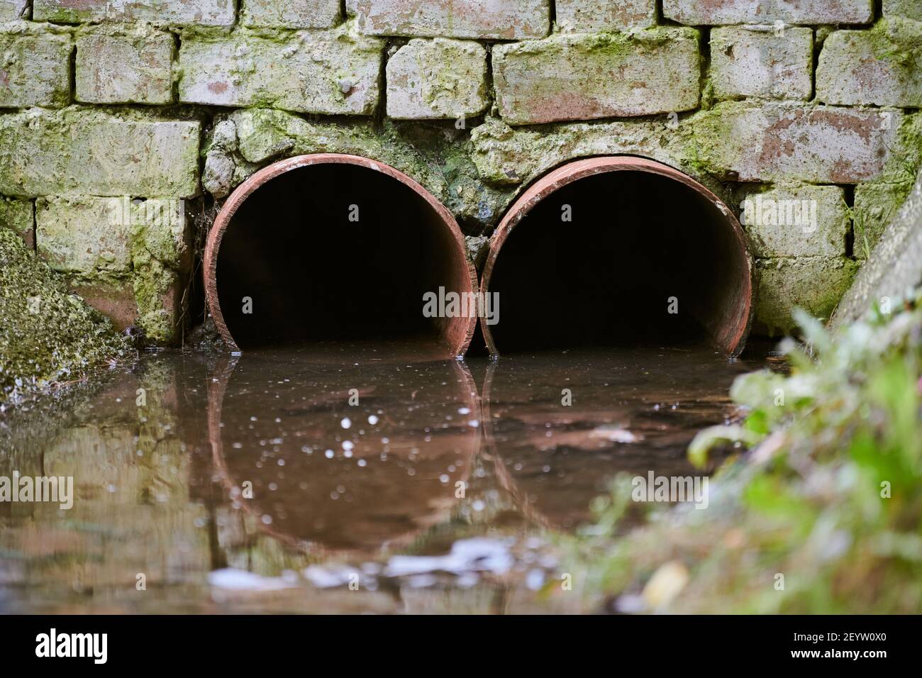 Sewers with toxic dirty water from metal pipes. Draining water from ...