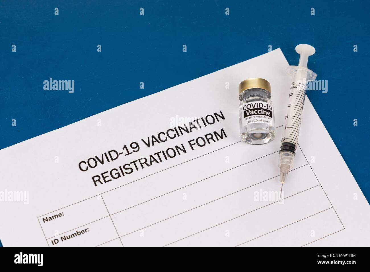 Covid-19 vaccination registration form with vial and syringe on blue ...