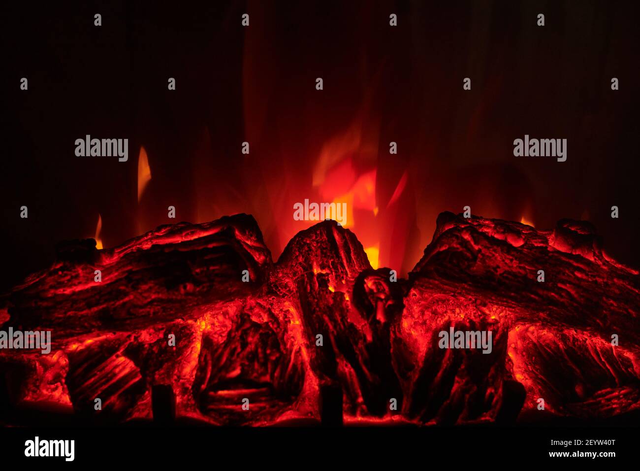 Artificial electric fireplace with orange, red and yellow flame. Fire ...